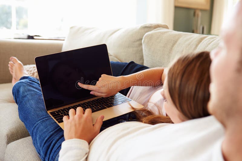 Couple Relaxing on Sofa Using Laptop Computer Together Stock Image ...