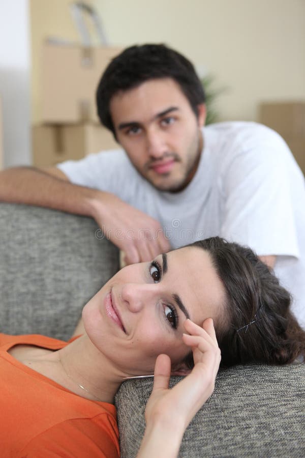 Couple Relaxing after Tiring Day Stock Photo - Image of earrings, couch ...