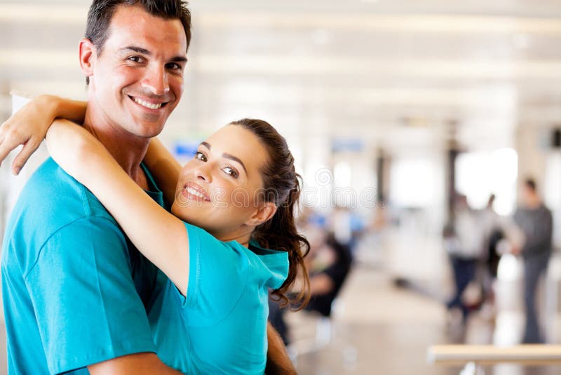 Couple reunion at airport stock image. Image of joyful - 23914927