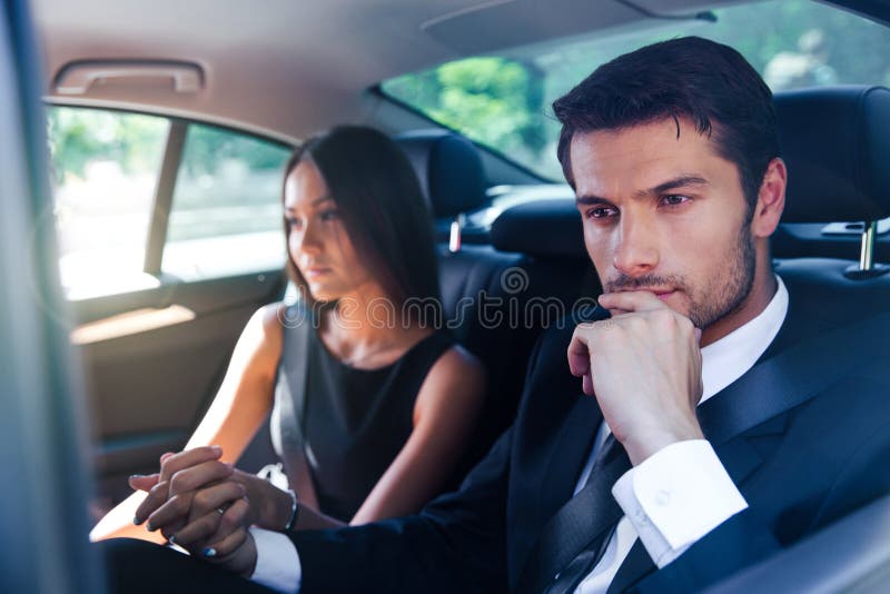 Couple Riding in Car Together Stock Photo - Image of serious, back ...