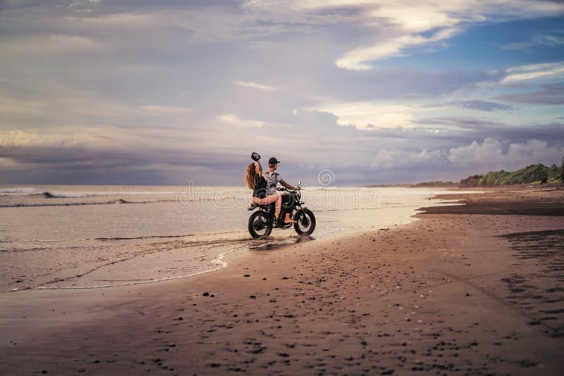 Couple Riding Motorcycle on Ocean Beach during Sunrise Stock Image ...