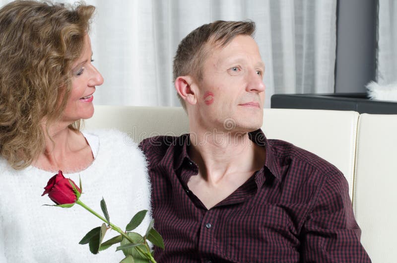 Couple with Rose Kissing on Couch Stock Image - Image of smiling ...