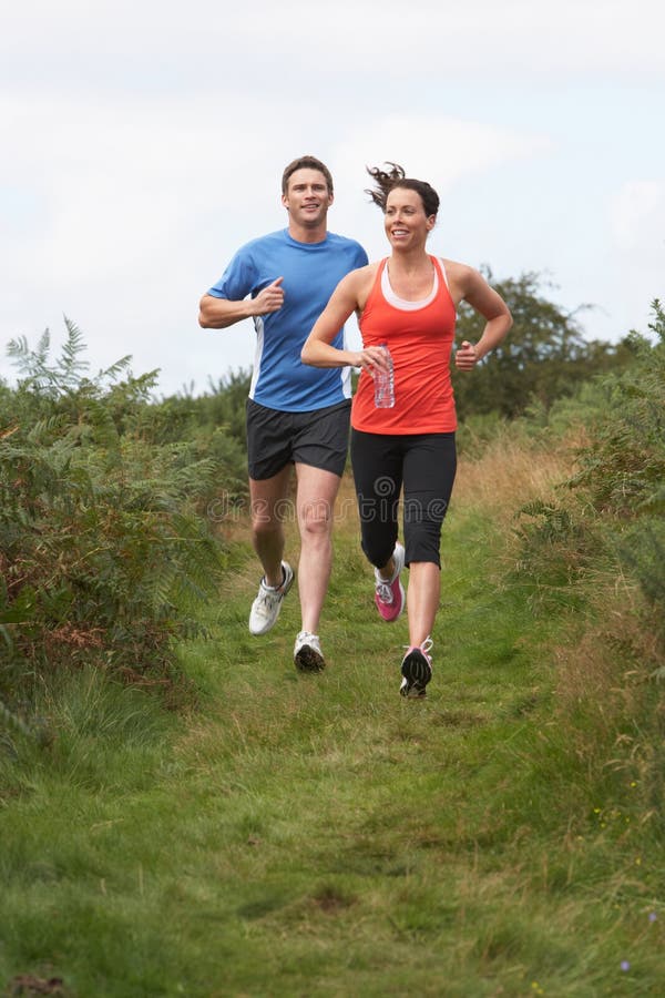 Couple on Run in Countryside Stock Photo - Image of pursuit, runner ...