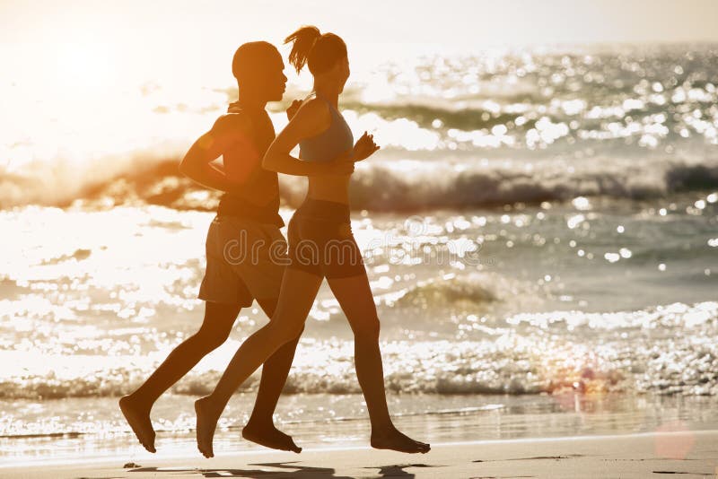 Couple Running Along the Beach at Sunset Stock Image - Image of ...