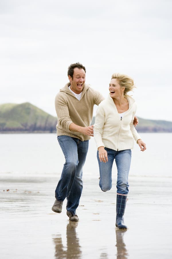 Couple Chasing One Another through Dunes Stock Photo - Image of ...