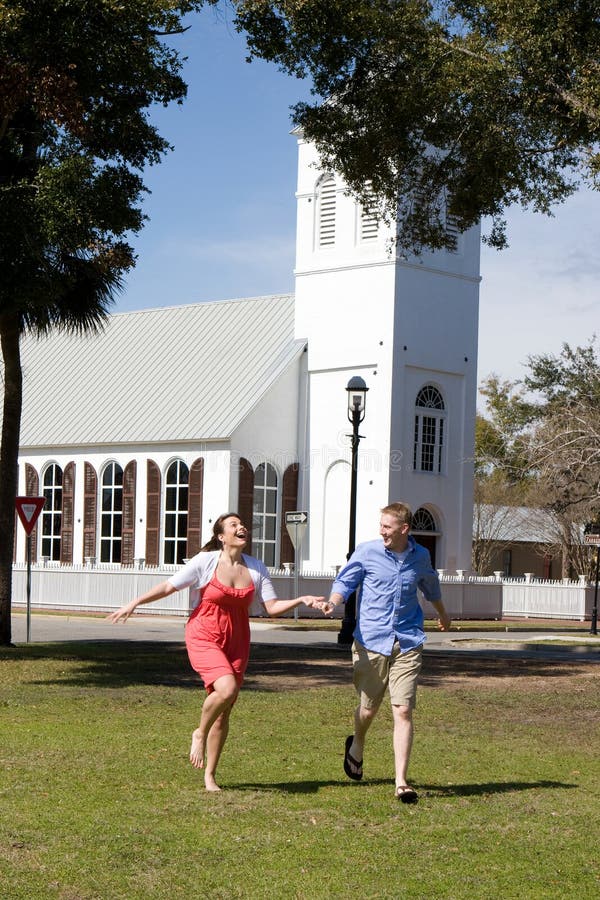 Couple Running by Church stock photo. Image of hands, church - 8457652
