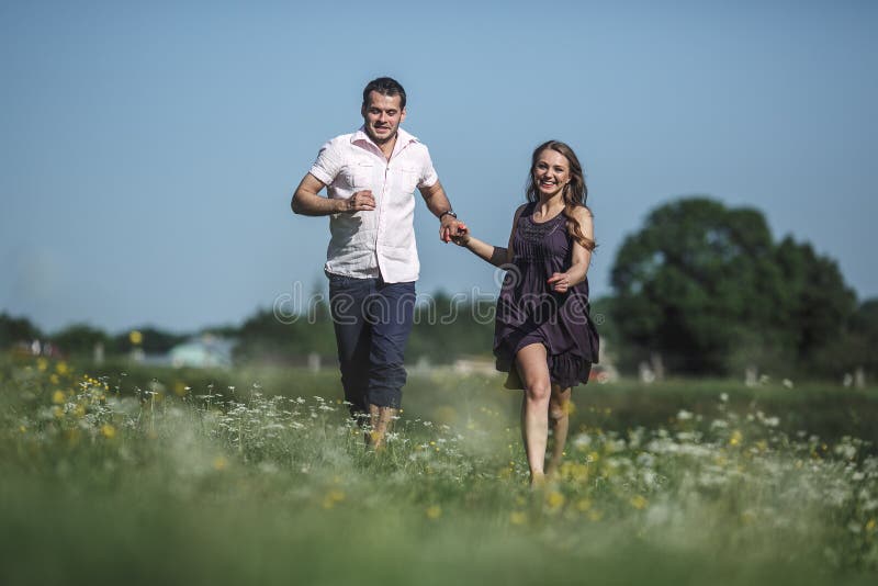 Couple running in field stock image. Image of healthy - 51642065