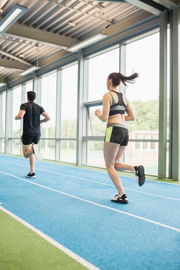 Couple Running on the Indoor Track Stock Photo - Image of attractive ...