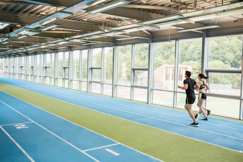 Couple Running on the Indoor Track Stock Photo - Image of caucasian ...