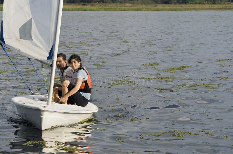 Couple Sailing Across Lake - Horizontal Stock Photo - Image of male ...