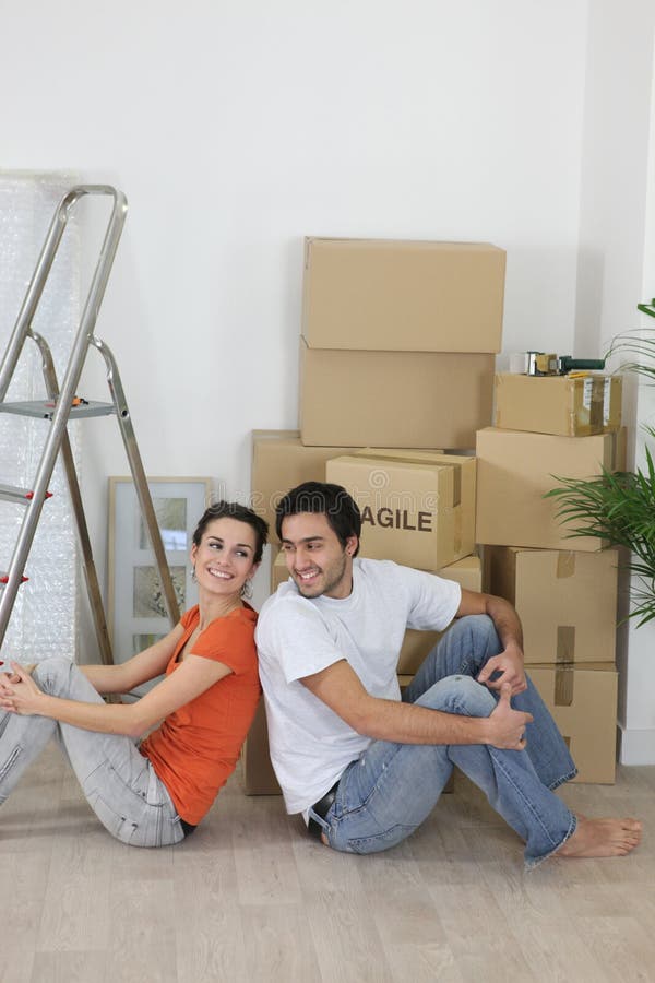 Couple Sitting on Floor by Open Boxes in New Home Stock Image - Image ...