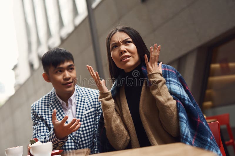 Couple Screeches in Coffee Shop at Table. Stock Image - Image of ...