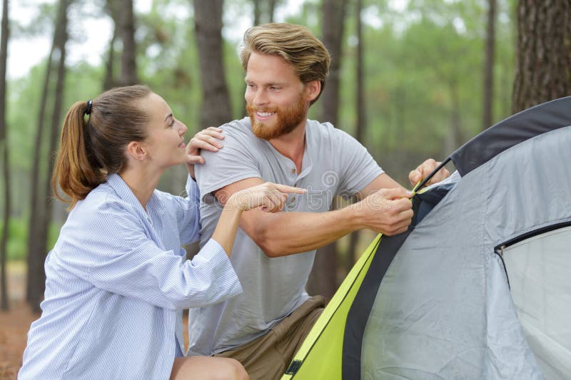 Couple securing tent stock image. Image of weekend, leisure - 273524607