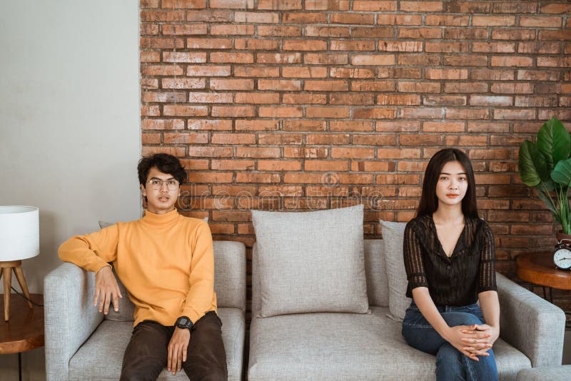 Couple Separating while Sitting on a Couch Stock Photo - Image of ...
