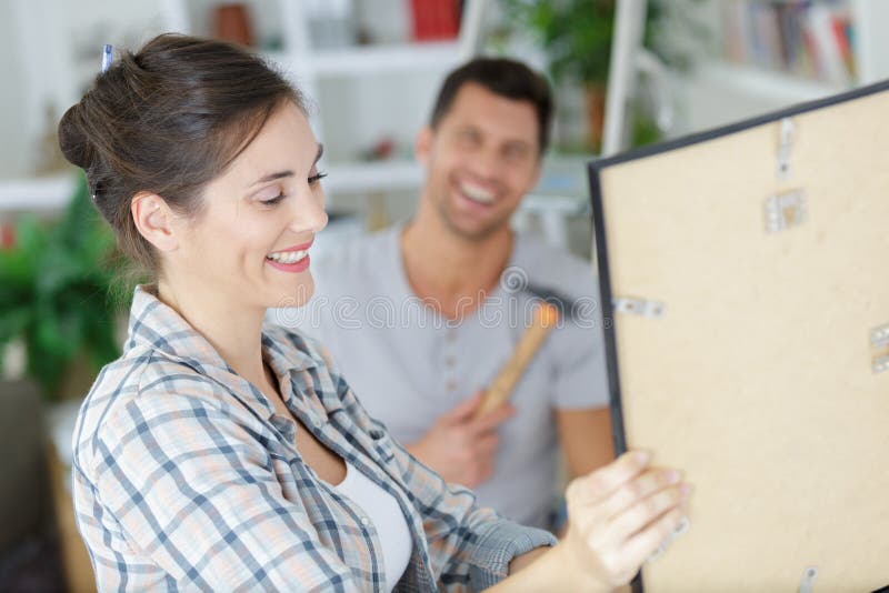 Couple Setting Up Picture Frame Stock Image - Image of relationship ...
