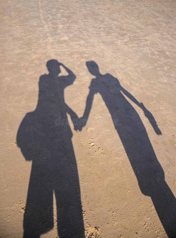 Couple shadow on the beach stock image. Image of shadow - 138877167