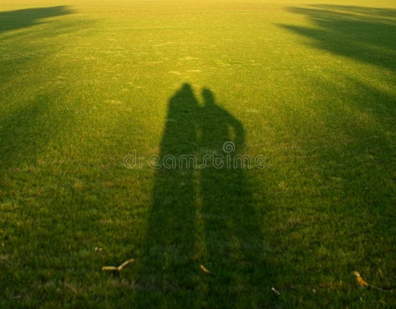 Couple shadow stock photo. Image of standing, grass - 144630642