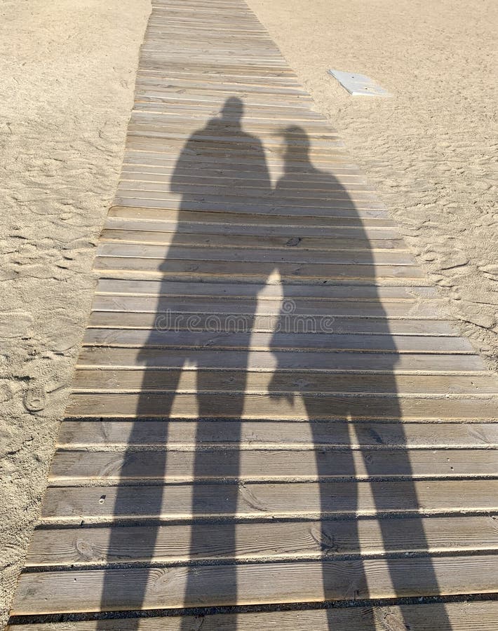 Couple in Shadow stock photo. Image of people, boardwalk - 352111198