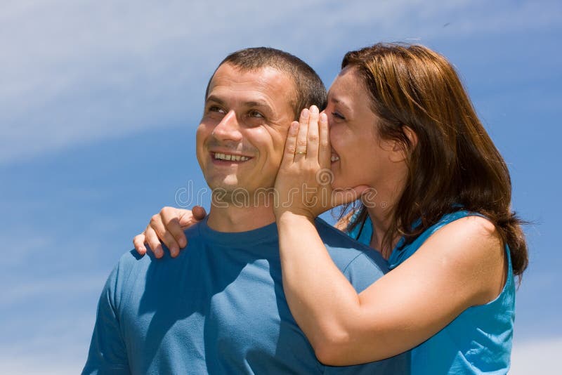 Couple sharing secrets stock photo. Image of beautiful - 5689262