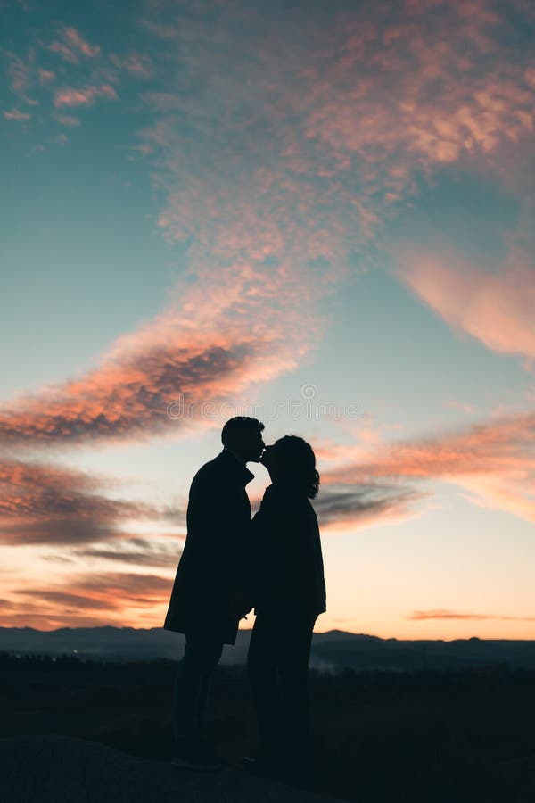 Couple Kissing Under Stunning Sunset Sky Stock Photo - Image of sunset ...