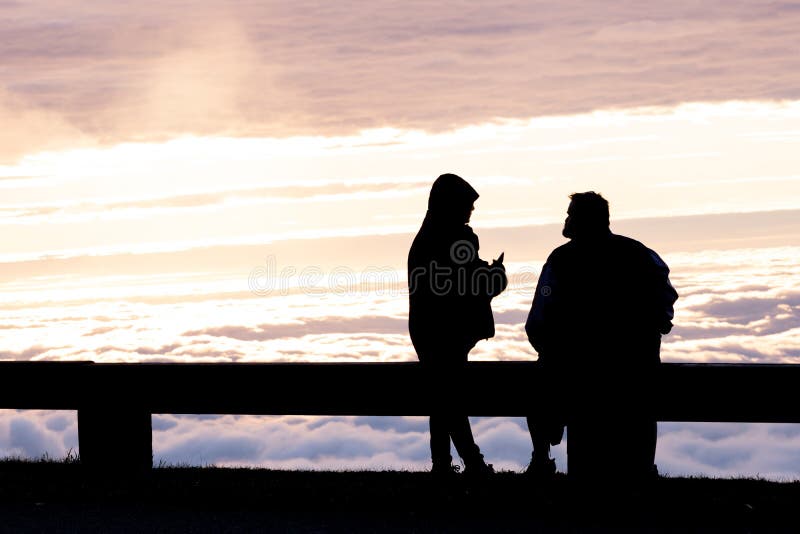 Couple Sit on Guardrail Along Blue Ridge Parkway and Enjoy Cloud ...
