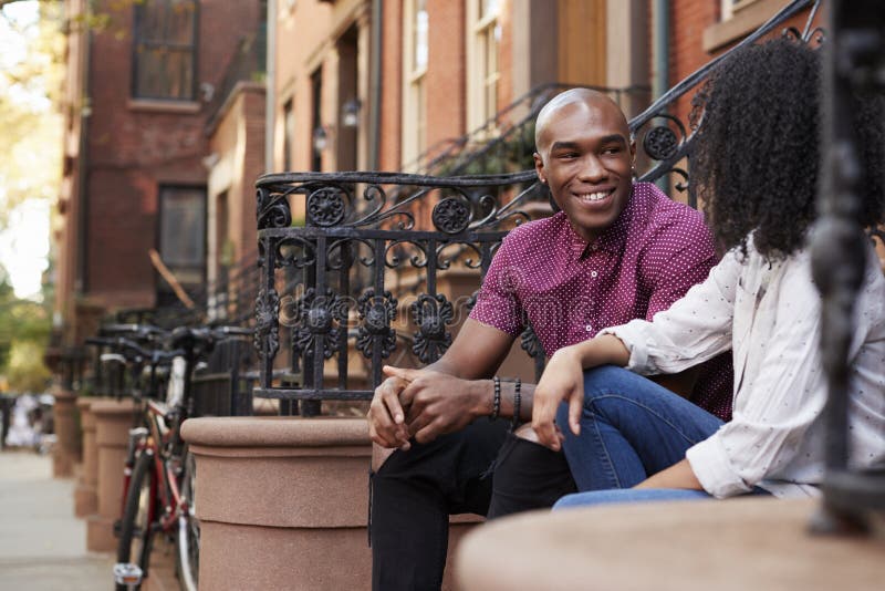 Couple Sit and Talk on Stoop of Brownstone in New York City Stock Image ...