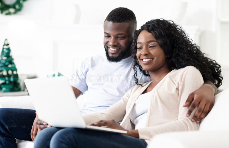 Couple Browsing Laptop on White Couch Stock Photo - Image of present ...