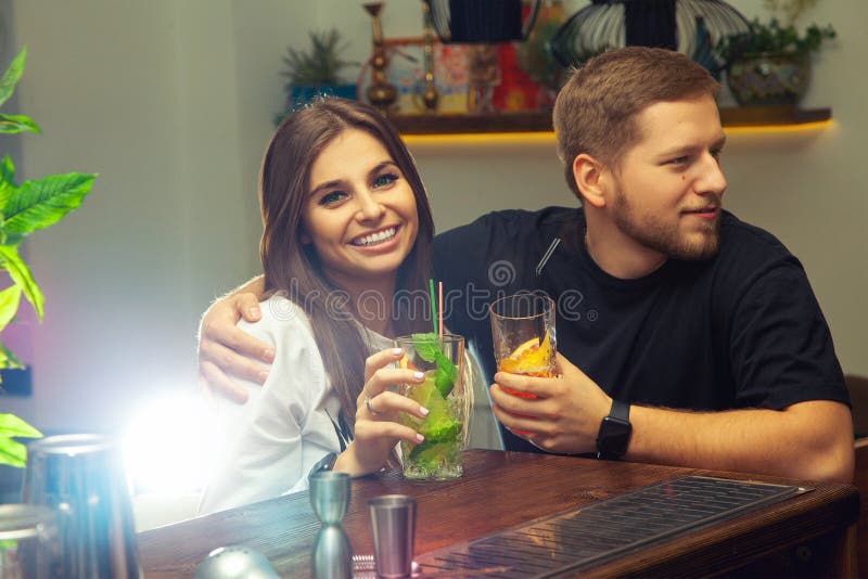 Couple Sitting with Cocktails at the Bar Stock Photo - Image of ...