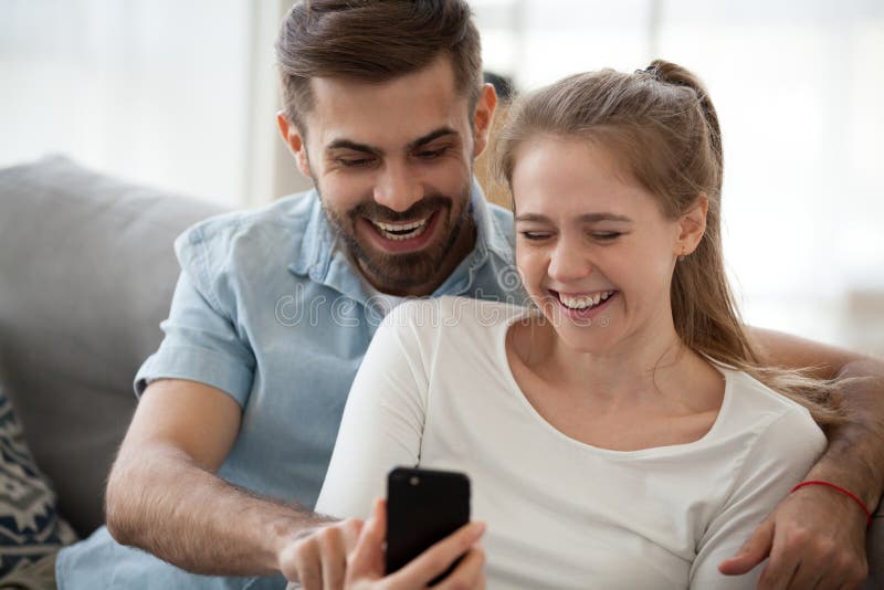 Couple Sitting On Couch Using Mobile Phone Stock Image Image Of Home