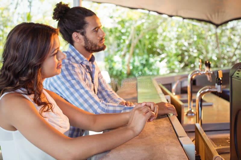 Couple sitting at counter stock photo. Image of leisure - 96346246