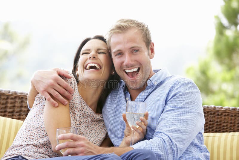 Couple Sitting on Outdoor Seat Together Stock Photo - Image of relaxed ...
