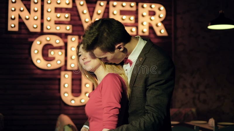 Couple Sitting on the Sofa in Arms and Caressing Each Other. Slow ...