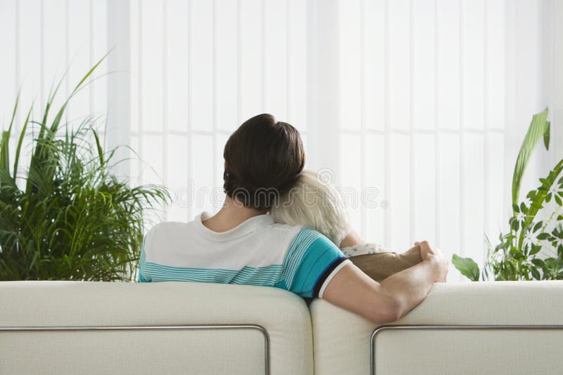 Couple Sitting on Sofa Hugging Back View Stock Photo - Image of indoors ...