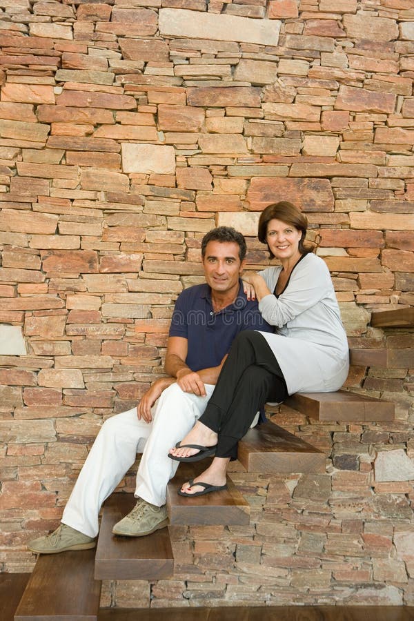 Couple sitting on steps stock image. Image of people - 62558995