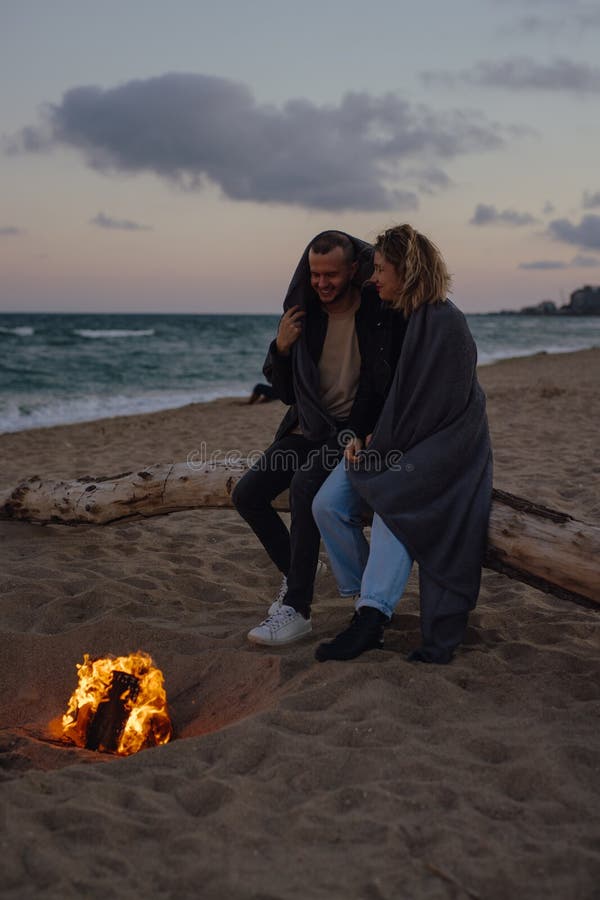 Couple Sitting Together Near Fire on the Beach Stock Image - Image of ...