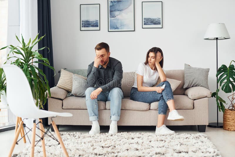 Couple Sitting Together on the Sofa in Domestic Room Stock Photo ...