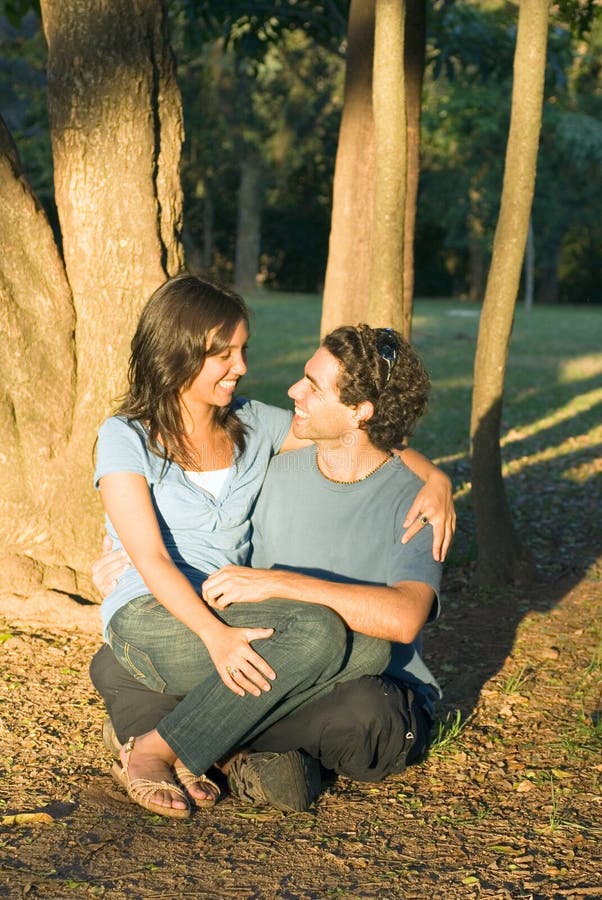 Couple Sitting Under A Shady Tree - Vertical Picture. Image: 5479632