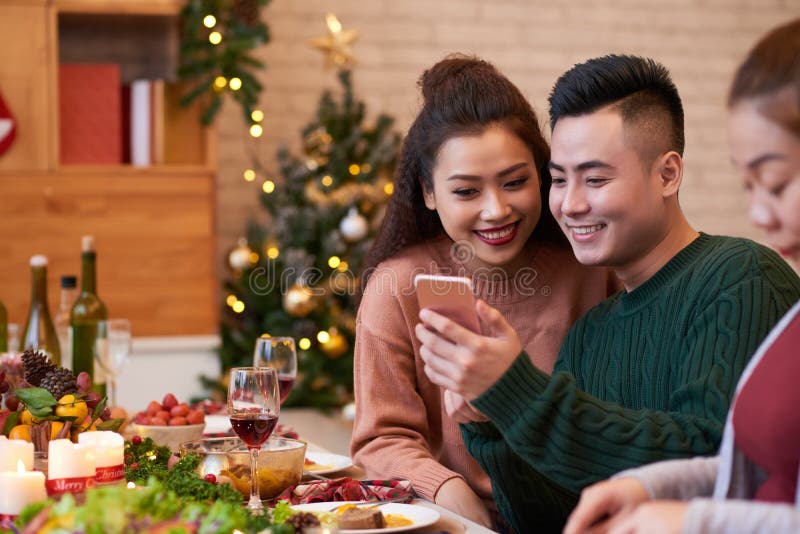 Couple with Smartphone at Dinner Table Stock Image - Image of young ...