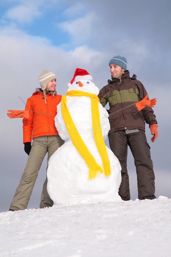 Group of Friends Building Snowman on Ski Holiday Stock Photo - Image of ...