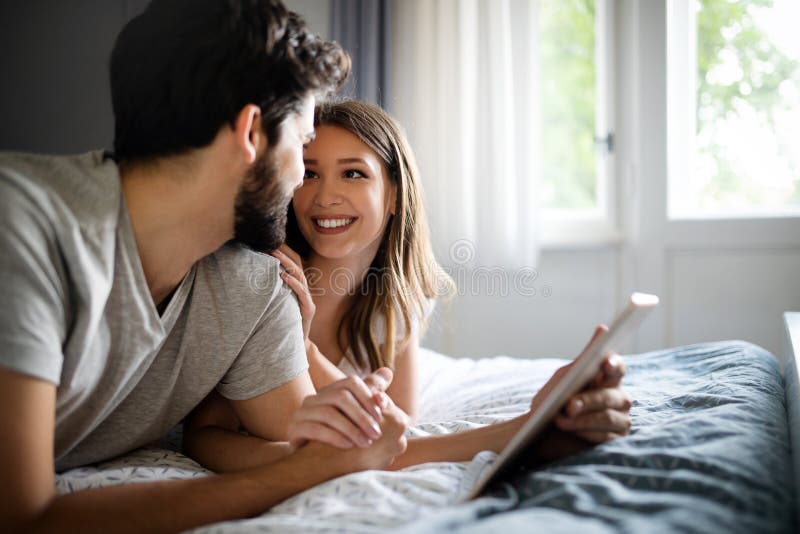 Happy Couple Spending Free Time on a Tablet at Home. Stock Image ...