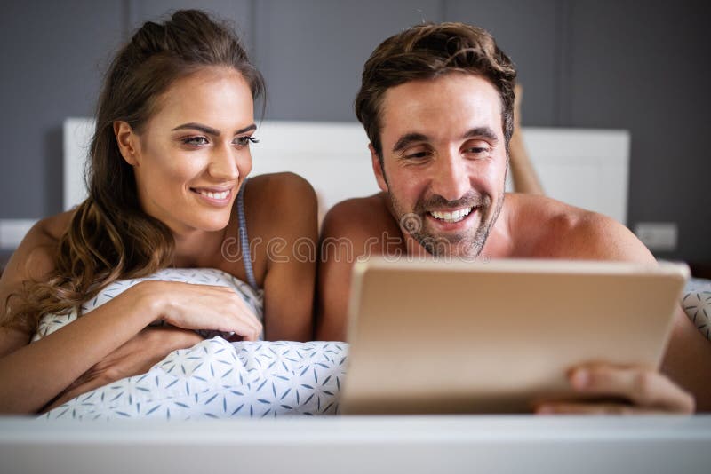Happy Couple Spending Free Time on a Tablet at Home. Stock Image ...