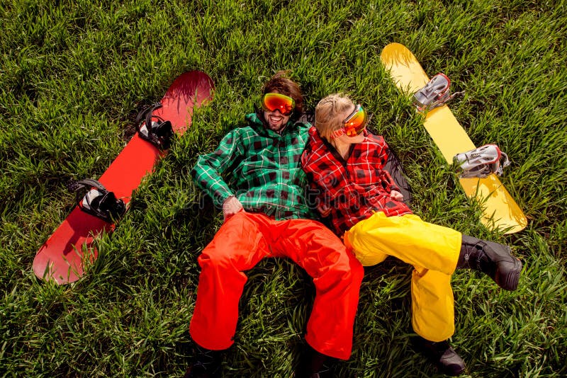 Couple in Sportswear with Snowboards Lying on the Grass Stock Photo ...