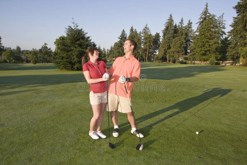 Couple Standing on Golf Course - Horizontal Stock Image - Image of ...