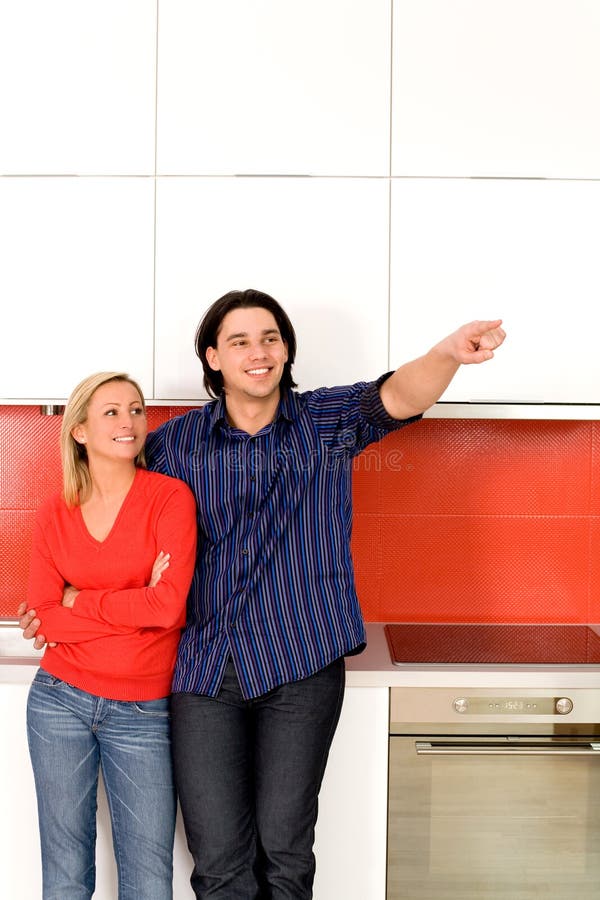 Couple standing in kitchen stock photo. Image of emotion - 8589310