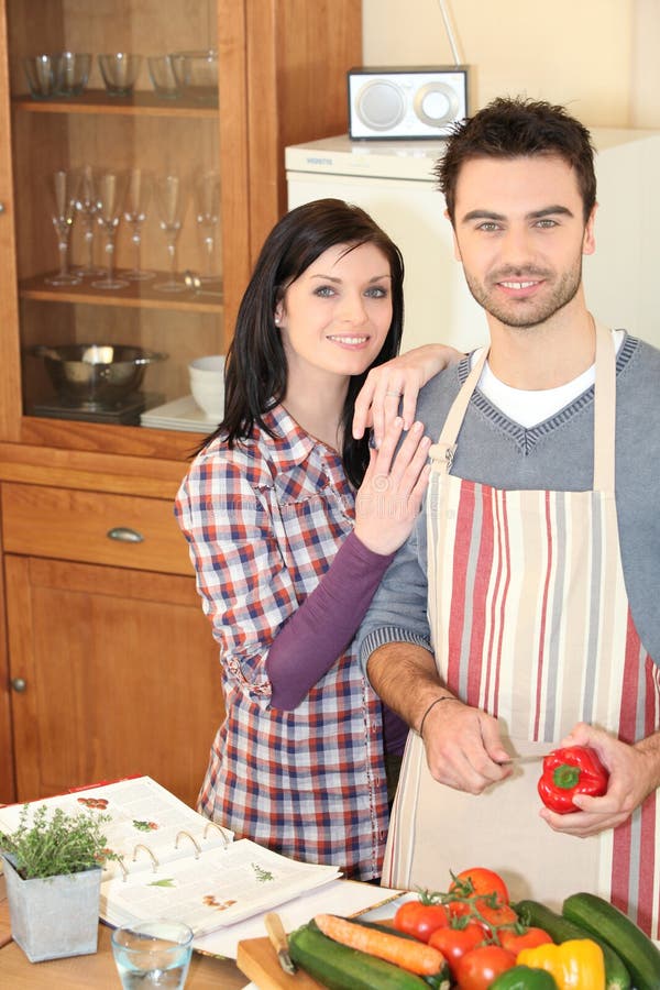 Couple standing in kitchen stock photo. Image of couple - 33940358
