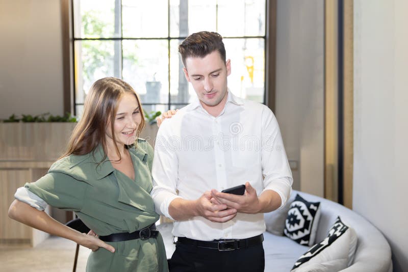 Couple Standing and Watching Mobile Phone Screen Stock Image - Image of ...