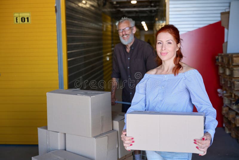 Couple is in a Storage Warehouse with a Cargo Trolley Stock Photo ...
