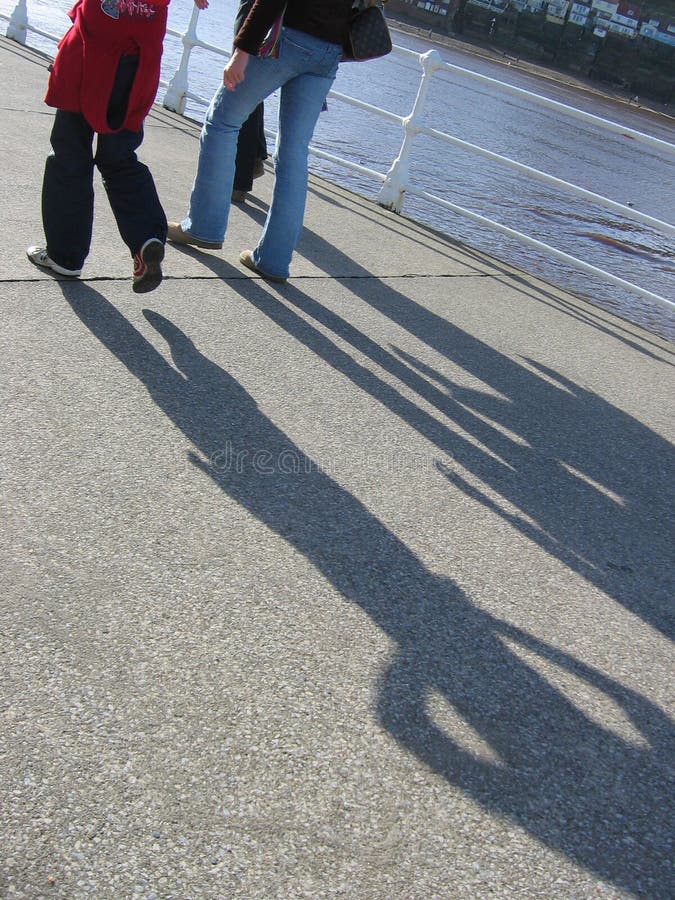 Couple strolling stock image. Image of walking, lesure, shadows - 72269