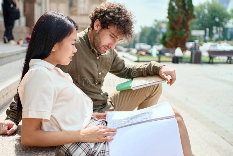 Couple of Students are Talking Sitting on the Steps . Stock Image ...