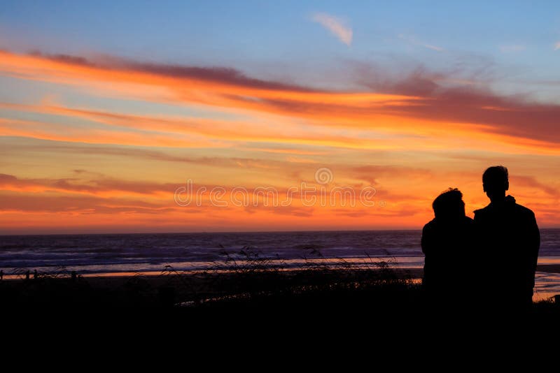 Couple at Sunset on Beach stock image. Image of skyscape - 66547695